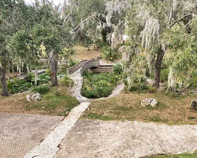 Winding garden paths invite exploration, leading visitors through grounds designed with the same unconventional vision that inspired the house itself.