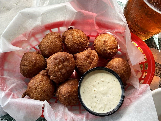 These golden orbs of cornmeal perfection arrive piping hot, crispy outside and fluffy inside &ndash; Southern comfort in bite-sized form.