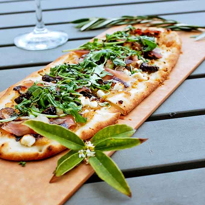 Flatbread so loaded with toppings it's practically a salad, which means it's healthy and you can have wine guilt-free, that's science.