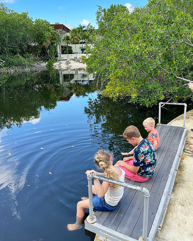 Childhood wonder in its purest form&mdash;young explorers dangle their feet from a dock, discovering that sometimes the best entertainment doesn't require batteries or screens.