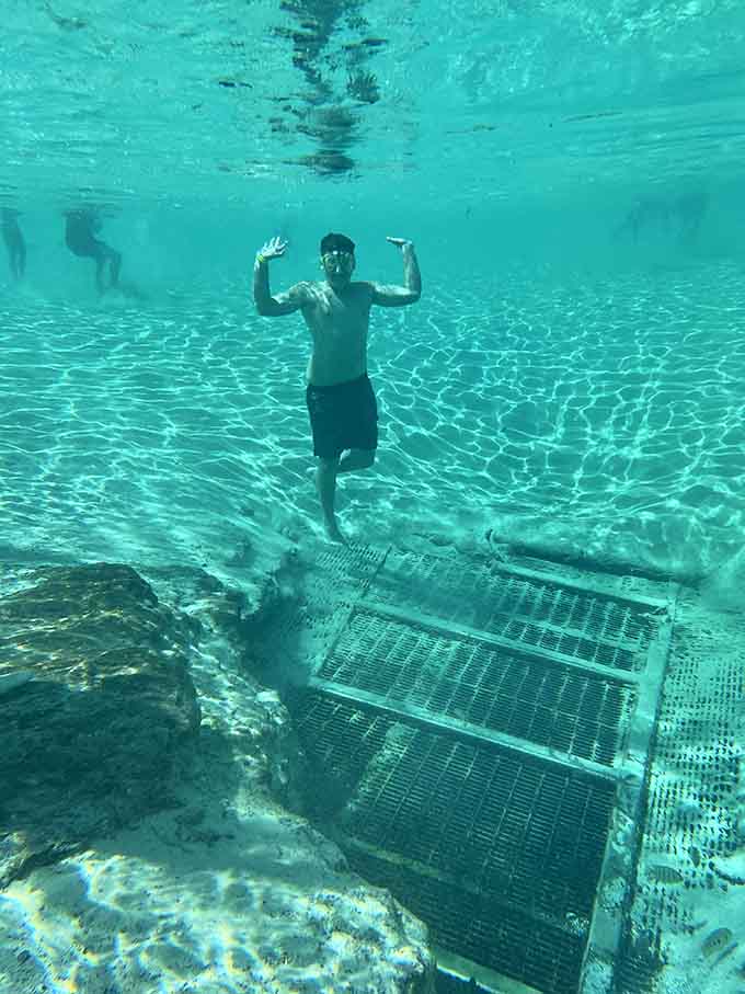 Swimming underwater in a natural spring is like being in your own private aquarium, except you're the exotic fish and everyone's watching you show off.