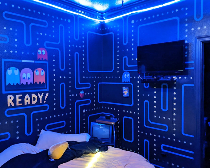 The Pac-Man bedroom glows with nostalgic blue light, creating a gaming sanctuary where wakka-wakka-wakka might become your new lullaby.