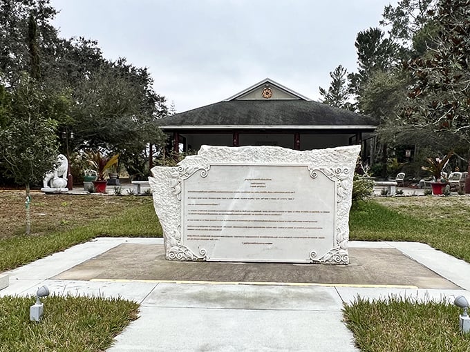 Carved wisdom etched in stone, this ornate plaque offers visitors a moment to pause and contemplate timeless teachings.