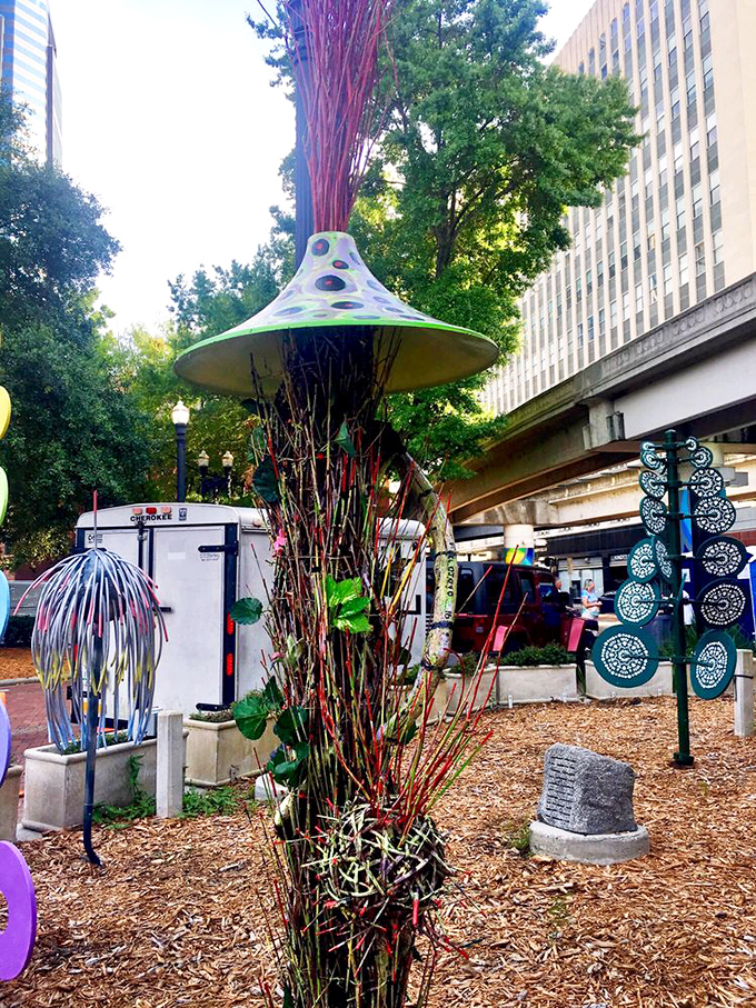 Whimsical mushroom sculptures sprout from the mulch, their polka-dotted caps adding a touch of fantasy to this urban wonderland.