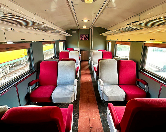 Alternating red and white seats create a parlor-like atmosphere, evoking train travel's elegance when journeys were about the experience.