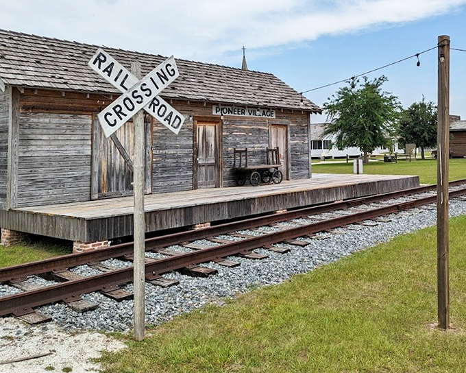 The railroad crossing sign stands as a reminder of when trains were new, exciting, and extremely dangerous without modern safety features.