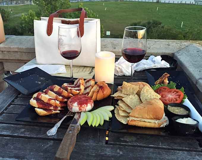 Wine, bread, and charcuterie spread across a wooden board create the kind of feast that makes time slow down.