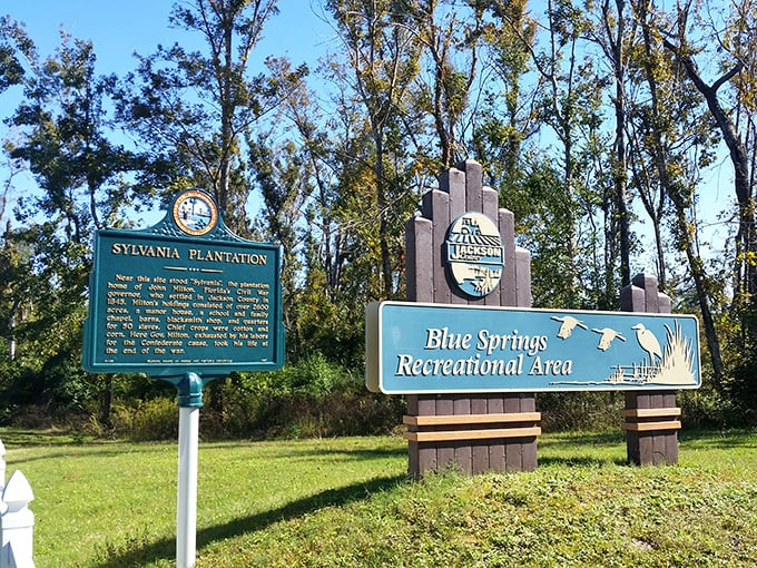Historical significance meets natural beauty at the park entrance, where signs tell the story of this geological wonder.