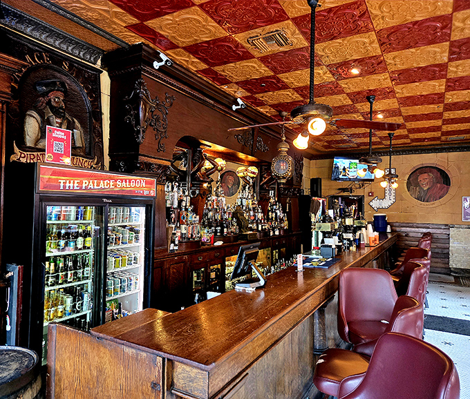 The bar's magnificent checkerboard ceiling of pressed tin creates a warm amber glow above bottles that have quenched thirsts for generations.