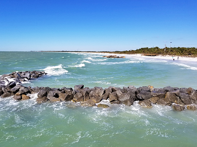 Where waves meet rocky guardians, creating nature's percussion section &ndash; a rhythmic soundtrack to beach days that feel stolen from ordinary life.