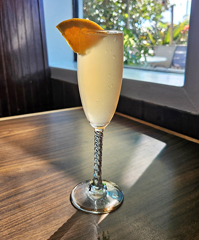 A refreshing citrus-kissed cocktail in an elegant glass &ndash; the perfect companion to seafood and sunset views.