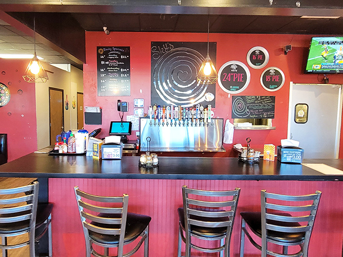 The bar area offers counter seating for solo diners or those looking to catch a game while enjoying their slice.