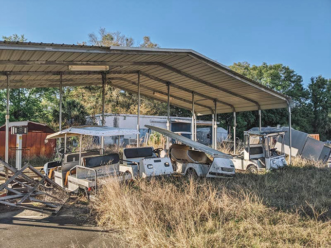 The golf cart parking area stands ready for vehicles that will never return, like a strange transportation graveyard for resort efficiency.