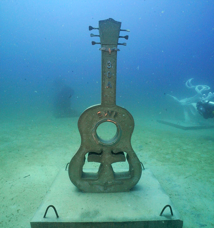 This guitar sculpture waits silently for Neptune's concert to begin &ndash; though fish seem to provide their own soundtrack.