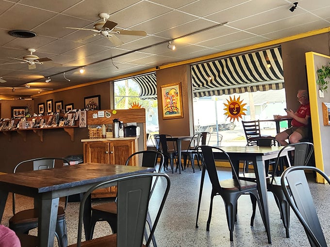 Metal chairs, wooden tables, and ceiling fans create that "stay awhile" atmosphere that chain caf&eacute;s try to replicate.
