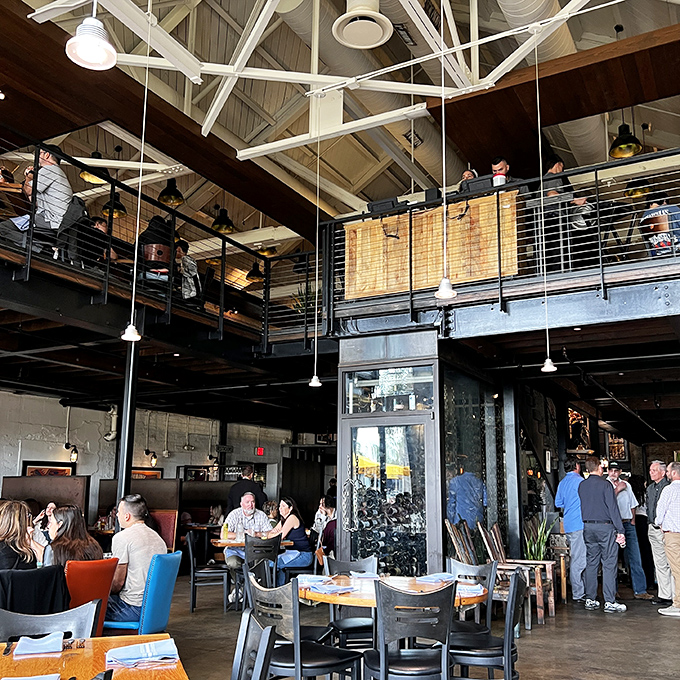 Ulele's two-story dining space balances industrial elements with warm woods, creating an atmosphere that's both impressive and inviting.