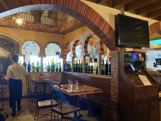 Wine bottles line the walls like soldiers standing at attention, ready to be called into delicious duty alongside your tapas feast.