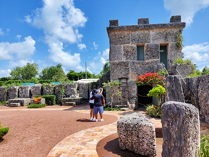 Visitors stand in awe before the stone tower, their expressions capturing the universal reaction: "How on earth did he do this?"