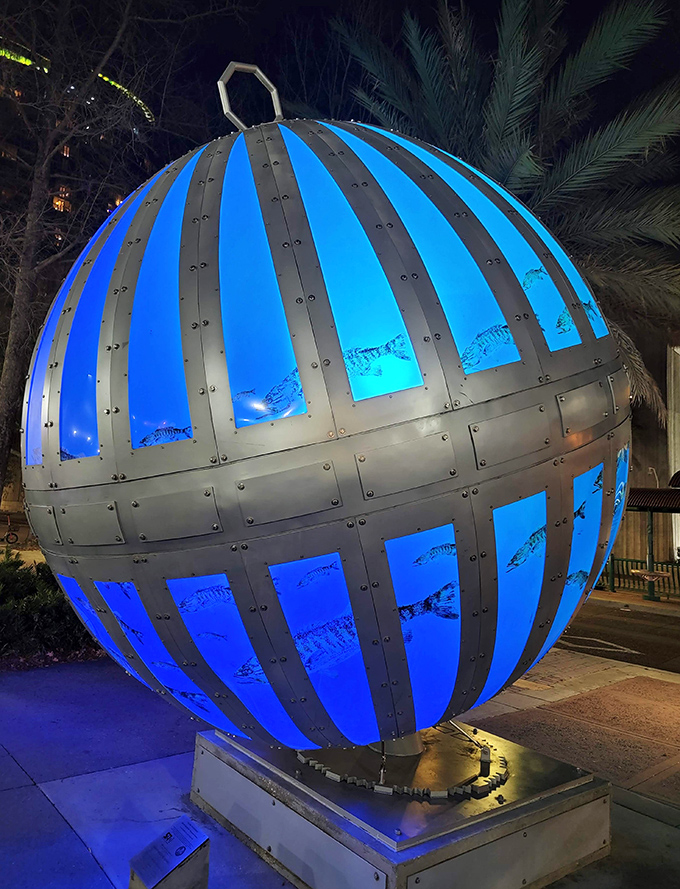 The internal lighting system transforms the sculpture after sunset, creating a magical blue glow that seems to hover between the downtown palm trees.