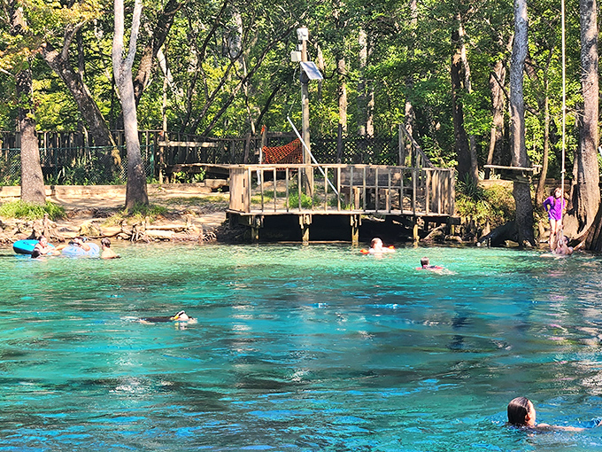 The wooden deck serves as nature's front porch, where strangers become friends united by their collective "wow" at this liquid jewel.
