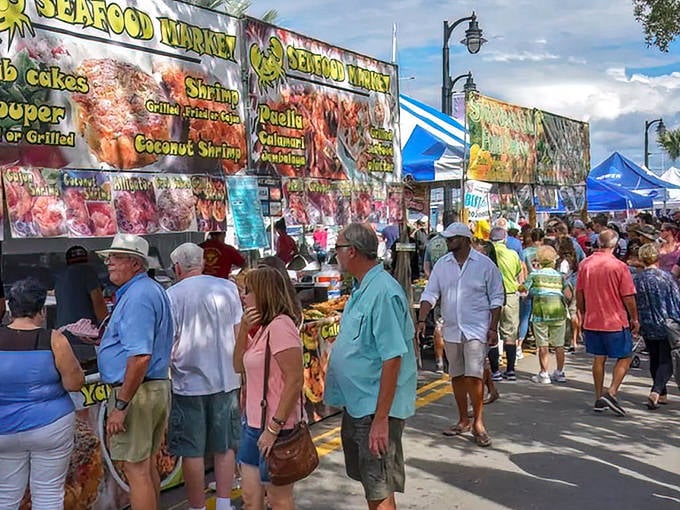 Seafood heaven! Hungry visitors line up at colorful food stalls offering everything from coconut shrimp to sizzling paella.