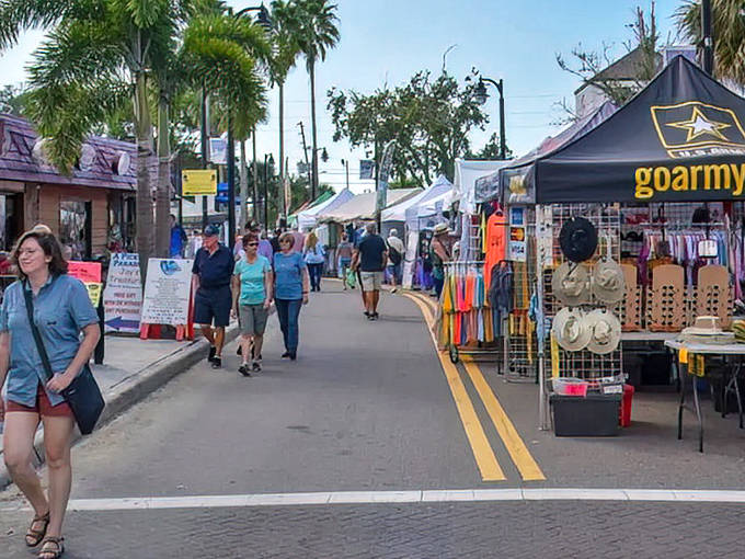 Small-town charm meets big flavor as festival-goers browse vendor booths along palm-lined streets at this springtime celebration.