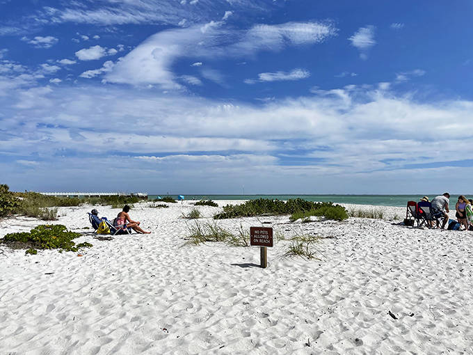Beach therapy in session: Visitors find their perfect spots along the shore, where worries dissolve faster than footprints at high tide.