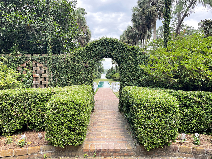 Stately oaks frame a historic building at Alfred B. Maclay Gardens, where Florida's natural beauty meets thoughtful human design.