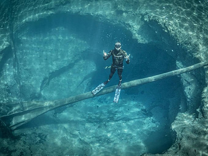 A diver explores Morrison Springs' underwater caves, where powerful flows create currents that challenge even experienced explorers.