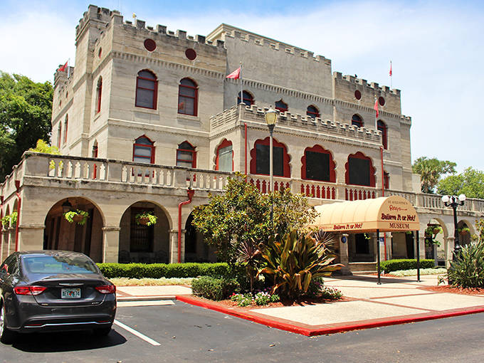 The castle's distinctive architecture features arched windows and detailed stonework, hinting at the strange and wonderful oddities displayed inside.