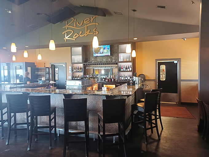 "River Rocks" glows above a well-stocked bar where mixologists craft drinks with the same care the kitchen gives to its seafood specialties.