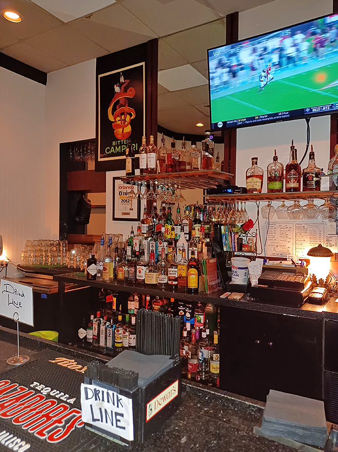 The bar stands ready like an altar to libations, vintage posters nodding approvingly at your classic cocktail choice.