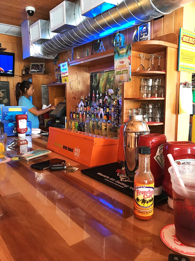 The bar area hums with activity, bottles standing at attention ready to complement the day's fresh catch with liquid refreshment.