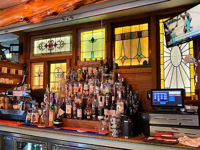 Stained glass and bottles creating a bar backdrop that's part art installation, part tropical paradise.