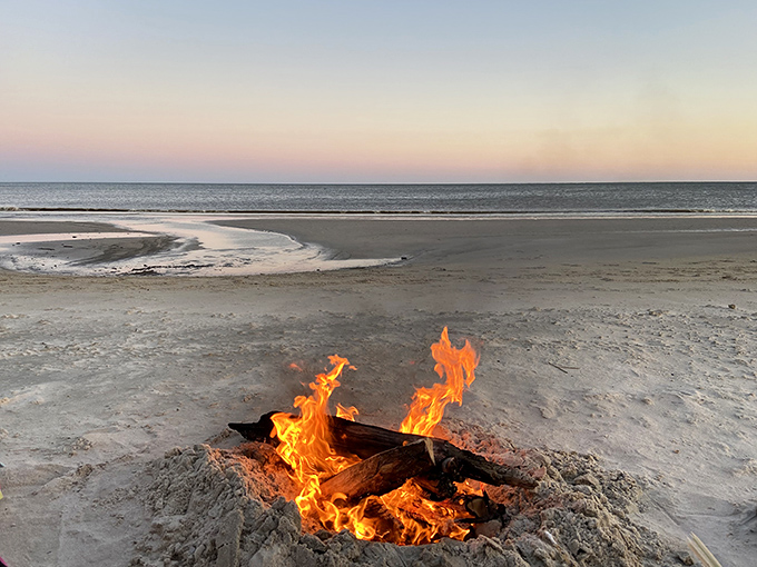 Beach bonfires create circles of warmth and light, where stories flow as freely as the waves under star-studded skies.