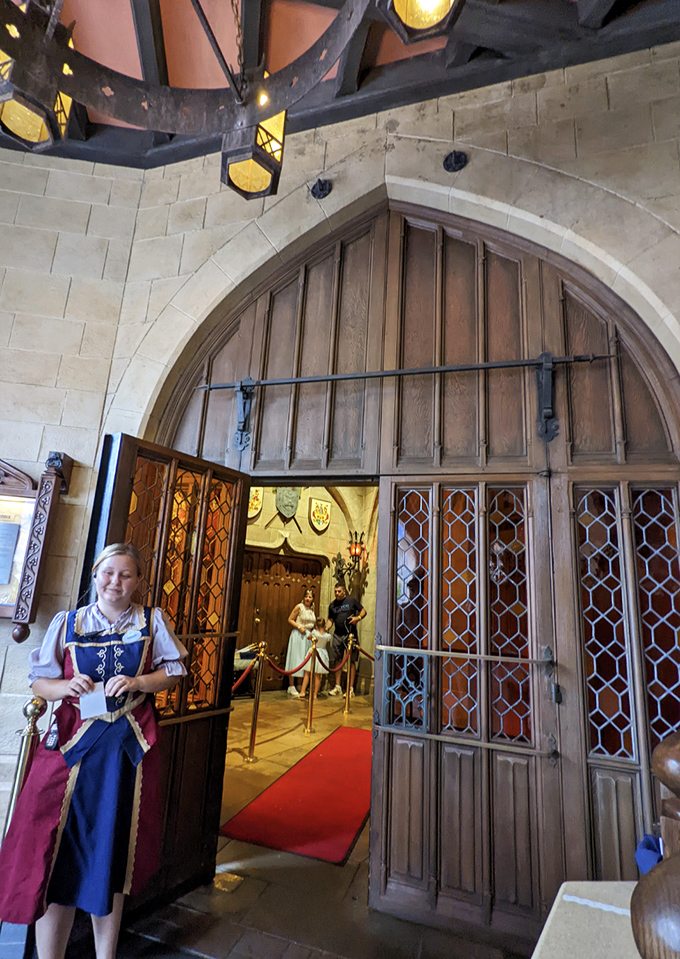 The castle entrance welcomes guests with medieval grandeur, complete with a royal attendant to usher you into the fairy tale.