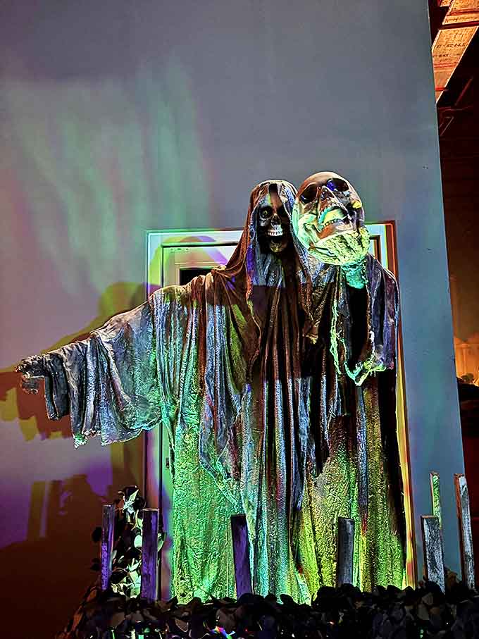 The Grim Reaper takes a stylish approach at Nightmare Village, proving that even harbingers of doom can have a flair for dramatic lighting.