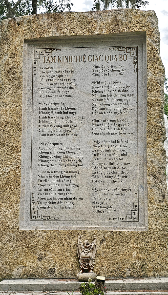 Ancient wisdom carved in stone &ndash; the Heart Sutra monument presents Buddhist teachings in Vietnamese text, surrounded by simple, natural elements.