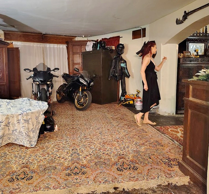 Even the interior spaces defy convention, with motorcycles sharing quarters with everyday furnishings in a surreal domestic tableau.