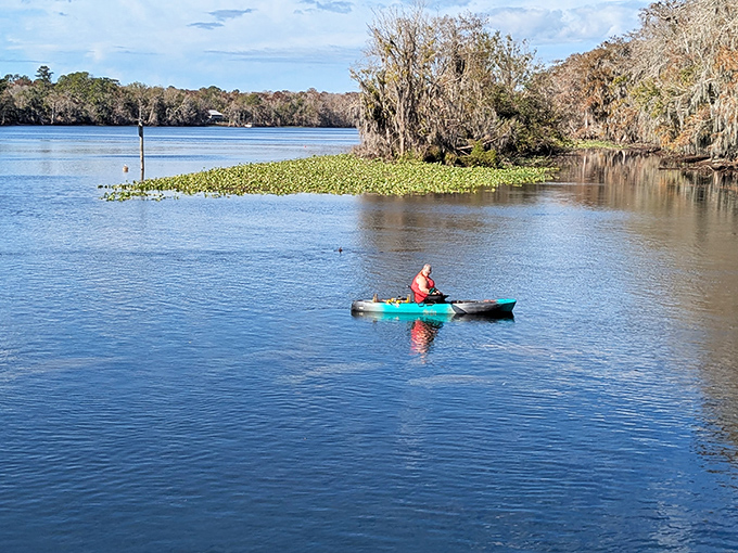 Solo adventurer carving ripples through liquid glass &ndash; proof that sometimes the best company is simply the river itself.