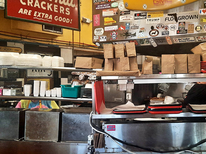 Behind the counter, where the magic happens &ndash; brown paper bags ready for to-go orders and decades of cooking expertise at work.
