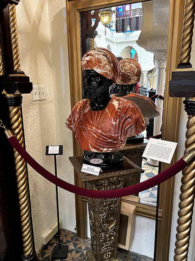 The train rests between journeys, its cheerful cars a splash of sunshine against the brick-paved streets of Old Town.