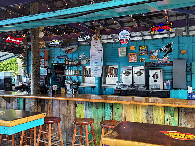 Beachside bar bliss: Weathered wood, turquoise accents, and a shark overhead create the quintessential Florida watering hole where stories flow as freely as drinks.
