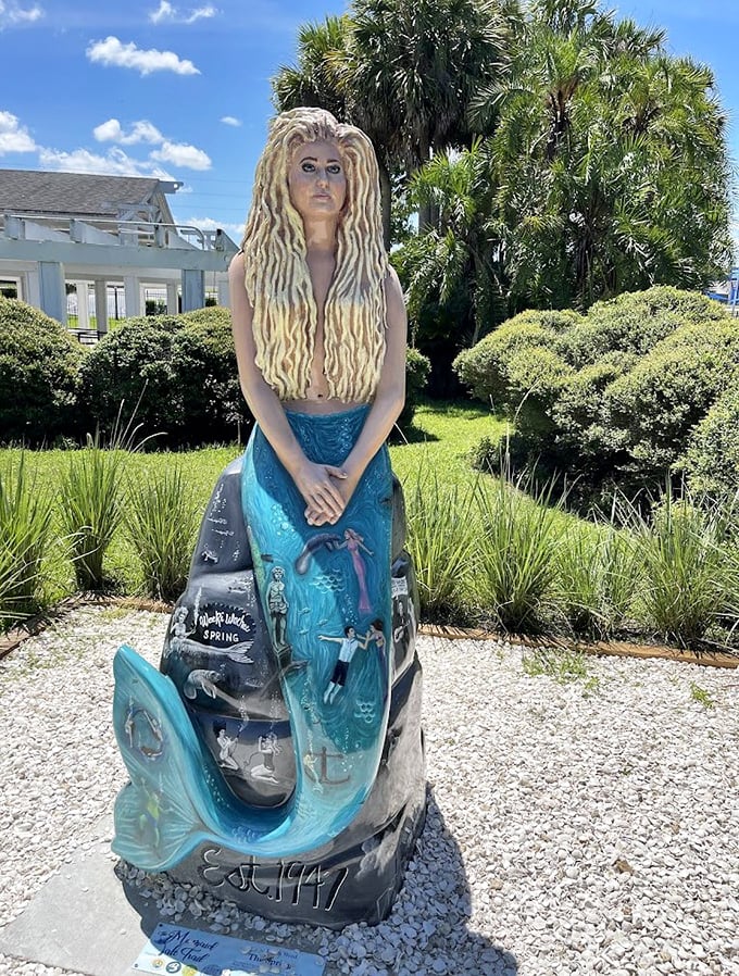 This weathered mermaid statue stands sentinel, her expression somewhere between serene and slightly unsettling after years of Florida sunshine.