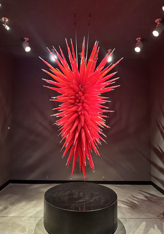 The Ruby Red Icicle Chandelier explodes downward in a controlled burst of crimson spikes, defying gravity while commanding the entire room.