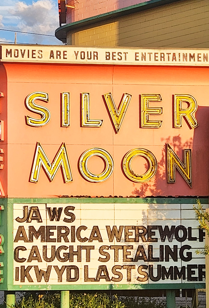 "Movies are your best entertainment" proclaims the vintage signage, showcasing tonight's double feature beneath the glowing Silver Moon letters.