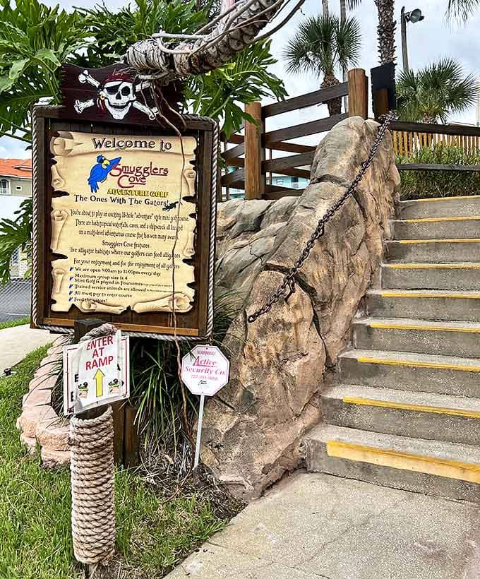 The weathered entrance sign, complete with skull and crossbones, sets the tone for adventure while providing practical information for would-be buccaneers.