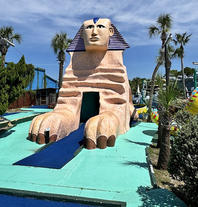 The sphinx guards its hole with ancient wisdom, silently judging your putting form with the patience of millennia.