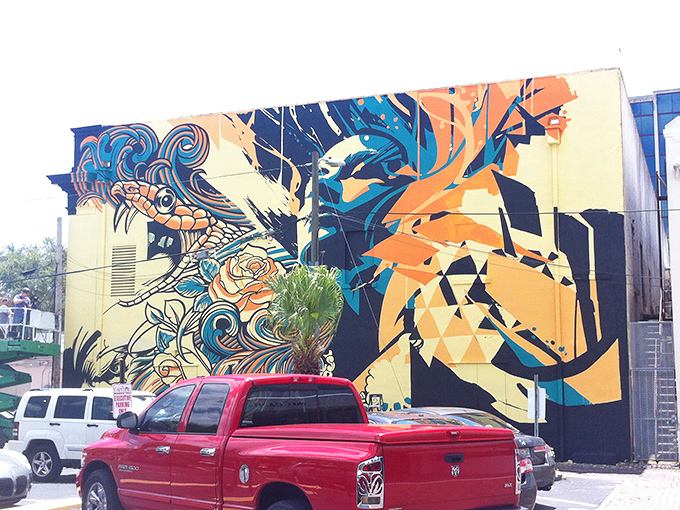 Bold lines and vibrant colors create a visual symphony in this geometric masterpiece that seems to dance across the building.