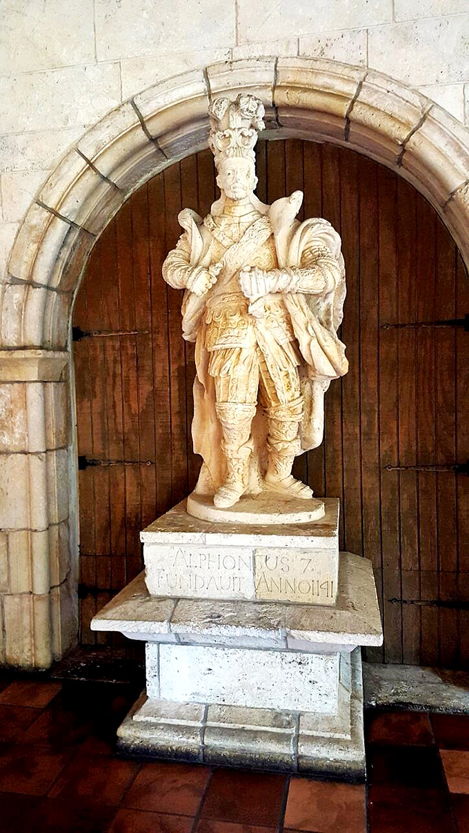 King Alphonsus VII looks surprisingly chill for someone who's been standing in this spot since the monastery's reconstruction.